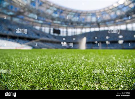 Grass On Stadium In Sunlight Closeup Of A Green Football Field Wet