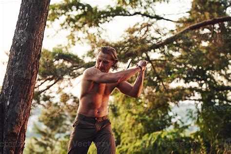 Process Of Cutting The Tree By Using The Axe Handsome Shirtless Man With Muscular Body Type Is