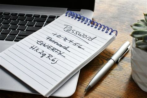 Premium Photo A Notebook With A Password Written On It Sits On A Desk Next To A Laptop