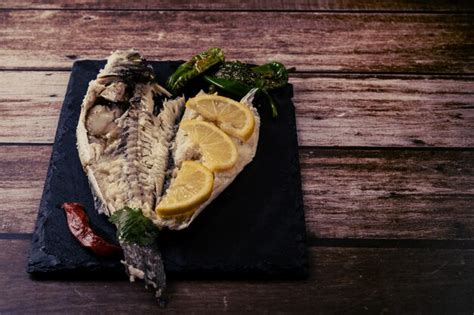 Fresh Sea Bass Cooked In Salt On A Black Board Premium Ai Generated Image