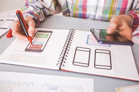 Premium Photo Developer Designing User Interfaces For Mobile Phone Applications