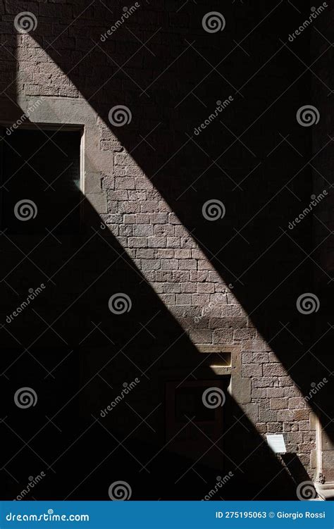 Diagonal Light Beam Passing Through A Stone Wall With Windows Contrast