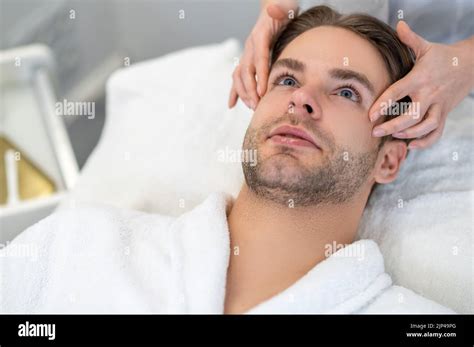 Young Male Client Having Face Massage In A Professional Salon Stock