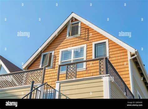 Low Angle View Of A House With Wood Shingles Wall Sidings And Side