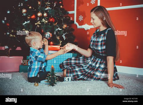 Beautiful Portrait Of Happy Mother And Son On The Background Of The Christmas Tree In New Year