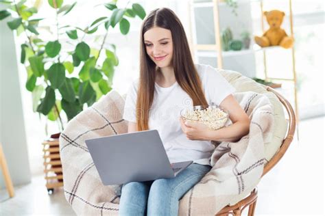 Portrait Of Attractive Focused Cheery Girl Watching Video Eating Snack Pastime Weekend Rest At