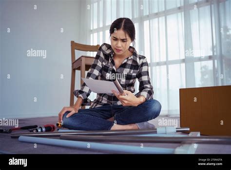 Women Stressful While Reading Installation Manual And Instruction Document For Assembling