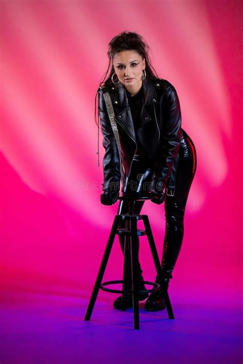 An Edgy Fashion Portrait That Features Vibrant And Dynamic Lighting For