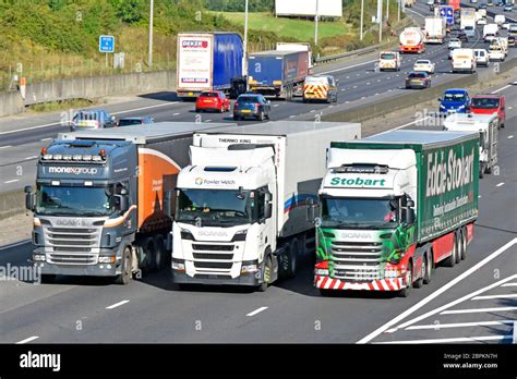 Drivers In Cabs Of Supply Chain Haulage Hgv Lorry Truck Articulated Trailer Overtaking In