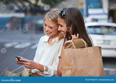 Ooh That Looks Cute A Woman Showing Her Friend Something On A