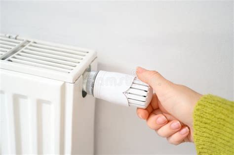 Hand Adjusting Home Radiator Thermostat For Heating Temperature Control In Winter Stock Image