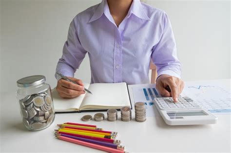 Premium Photo Midsection Of Businesswoman Calculating Graph On Table