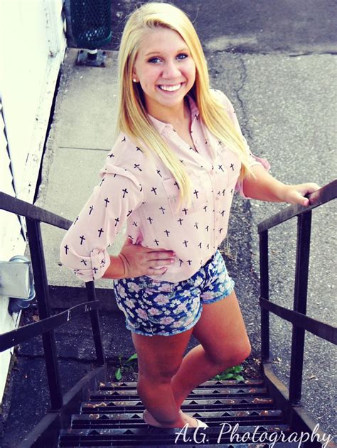 A Beautiful Blonde Woman Standing On Top Of A Set Of Stairs