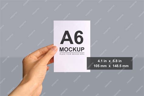 Premium PSD | Realistic hand holding a6 paper mockup portrait a6 ...