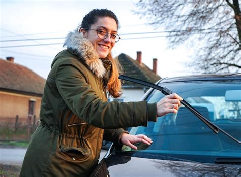 Premium Photo Portrait Of Smiling Young Woman Holding Windshield