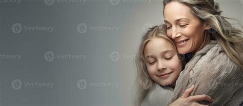 Middle Aged Mom Hugging Daughter On Grey Background Stock Photo At Vecteezy