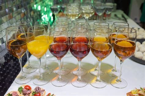 Premium Photo Group Of Glasses With Different Wines On Table Against
