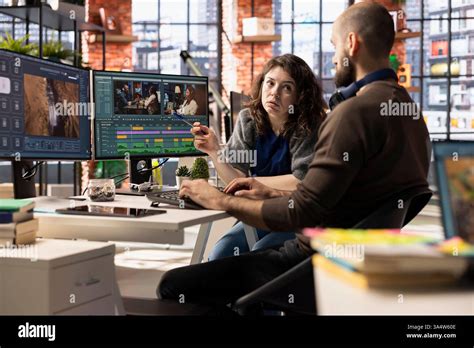 Creative Couple Working Together On Video Editing Software For Movie