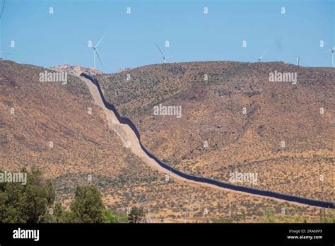 The United States Border Wall With Mexico Cuts Through The Landscape