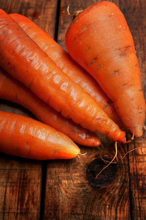 Selective Focus Close Up Photo Of Carrots On Wooden Surface · Free