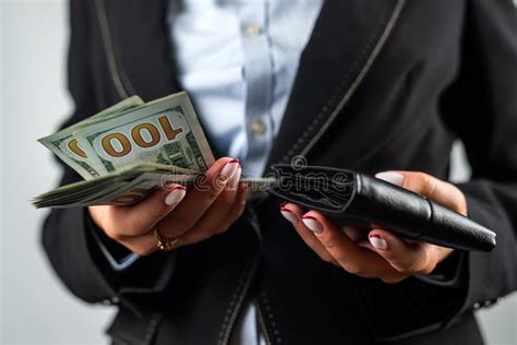 Close Up Of A Womanand X27s Hands Putting A Hundred Dollar Bill Into Her