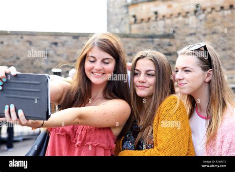 Three Pretty Young Girls Taking A Selfie At Edinburgh Castle Stock