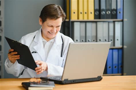 Portrait Of Female Doctor Counseling Patient Via Video Call