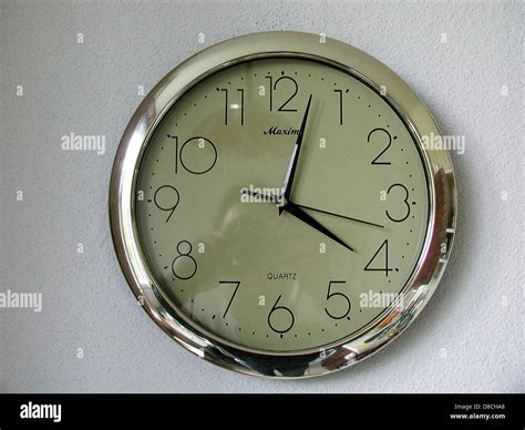 A Close Up Shot Of A Chrome Clock With A Sleek Modern Design The