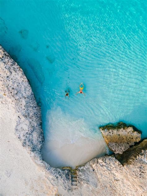 A Couple Of Men And Women On The Beach Of Tres Trap Aruba Caribbean