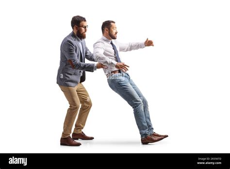 Full Length Profile Shot Of A Man Catching Another Man Falling Isolated