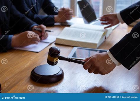 Team Of Lawyers Having Legal Discussion Holding Judges Mallet In Their