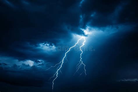 Lightning Bolt Striking Down From Dark Storm Clouds In Night Sky