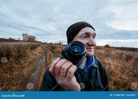 Amateur Photographer Enjoying The Autumn Scenery Of The Forest Road