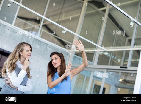 Female executives interacting with each other in office Stock Photo - Alamy