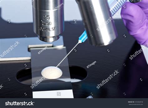 Photo Of A Sperm Sample On A Microscope Slide With A Syringe Being Used To Extract An Embryology