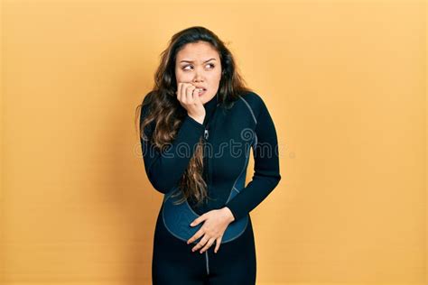 Young Hispanic Girl Wearing Diver Neoprene Uniform Looking Stressed And