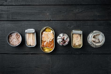 검은 색 나무 테이블 배경에 물고기의 다른 유형으로 통조림 캔의 구색 상단 보기 평면 누워 카피 스페이스와 텍스트 공간을 0명에 대한 스톡 사진 및 기타 이미지 Istock