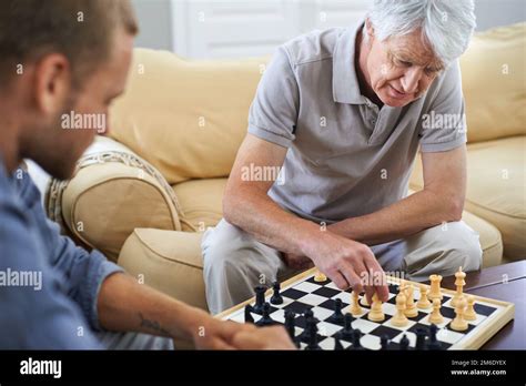 Hes Got A Well Thought Out Strategy A Father And Son Playing A Game Of