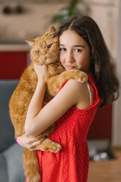 Premium Photo Beautiful Girl In A Red Dress Holds Her Beloved Red
