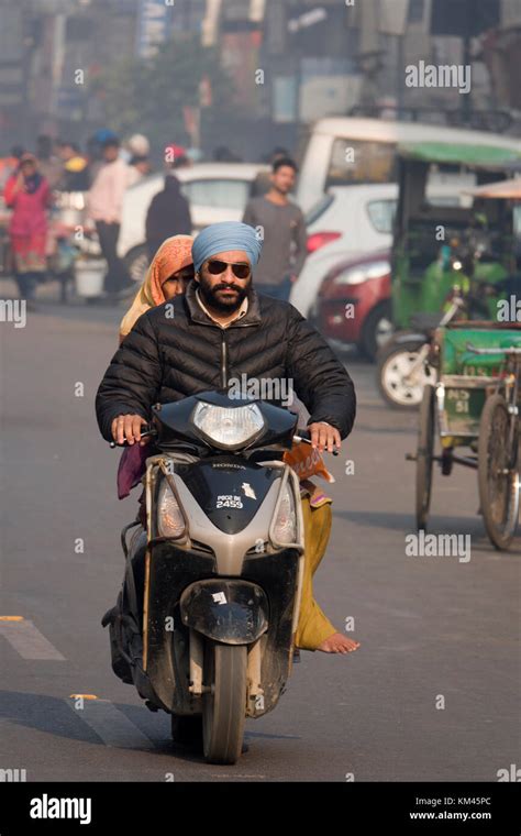 Sikh Man And Woman Riding Motorbike In Amritsar Punjab India Stock