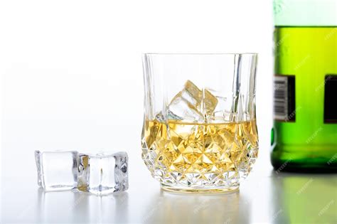 Premium Photo Glass Of Whiskey And Ice On White Background