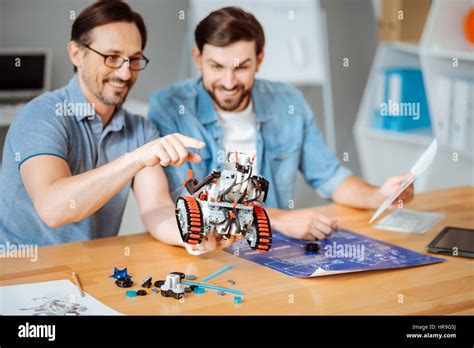 Positive Engineers Examining The Robot Stock Photo Alamy