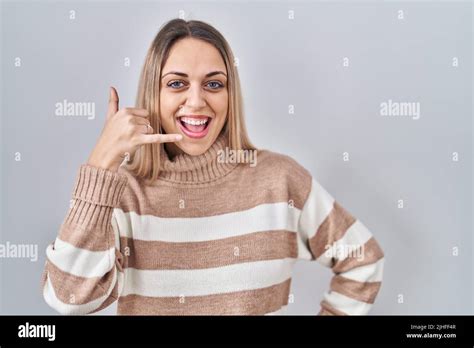 Young Blonde Woman Wearing Turtleneck Sweater Over Isolated Background