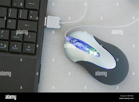 Studio Still Life Illuminated Mouse Connected To USB Port On Laptop Computer Stock Photo Alamy