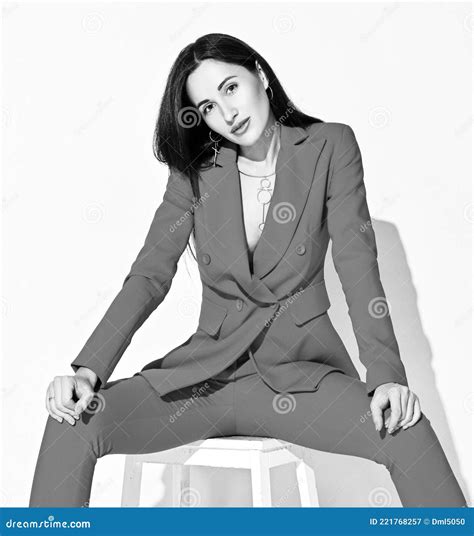 Black And White Portrait Of Young Brunette Woman In Official Pantsuit