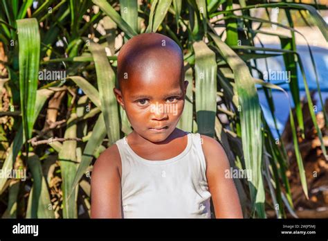 Village African Girl With Shaved Head Wearing A White Vest In The