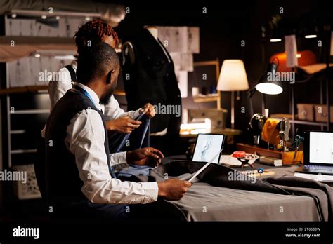 Tailors Working With Exquisite Fabrics In Professional Atelier Shop