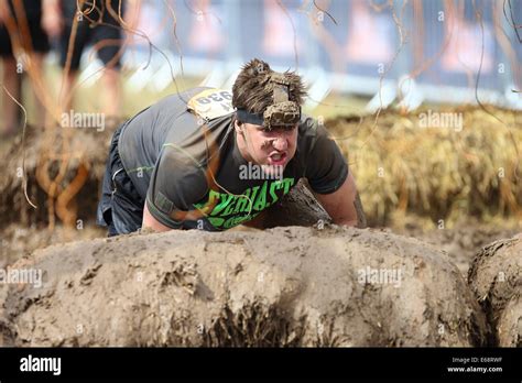A Tough Mudder Tackling The Shock Therapy Obstacle Stock Photo Alamy