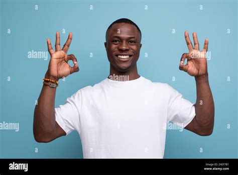 Nice Young African Guy In White T Shirt Smiling Showing Class With