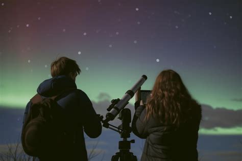 Premium Photo Couple With Telescope And Camera Capturing Images Of Solarinduced Auroras